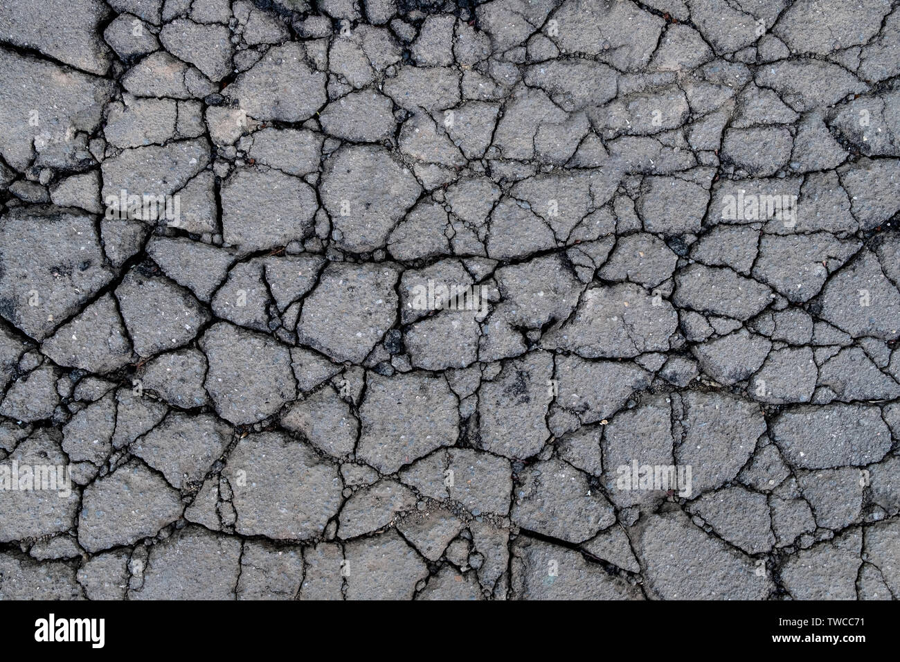 Old worn and cracked asphalt with cracks. Cracked asphalt background ...