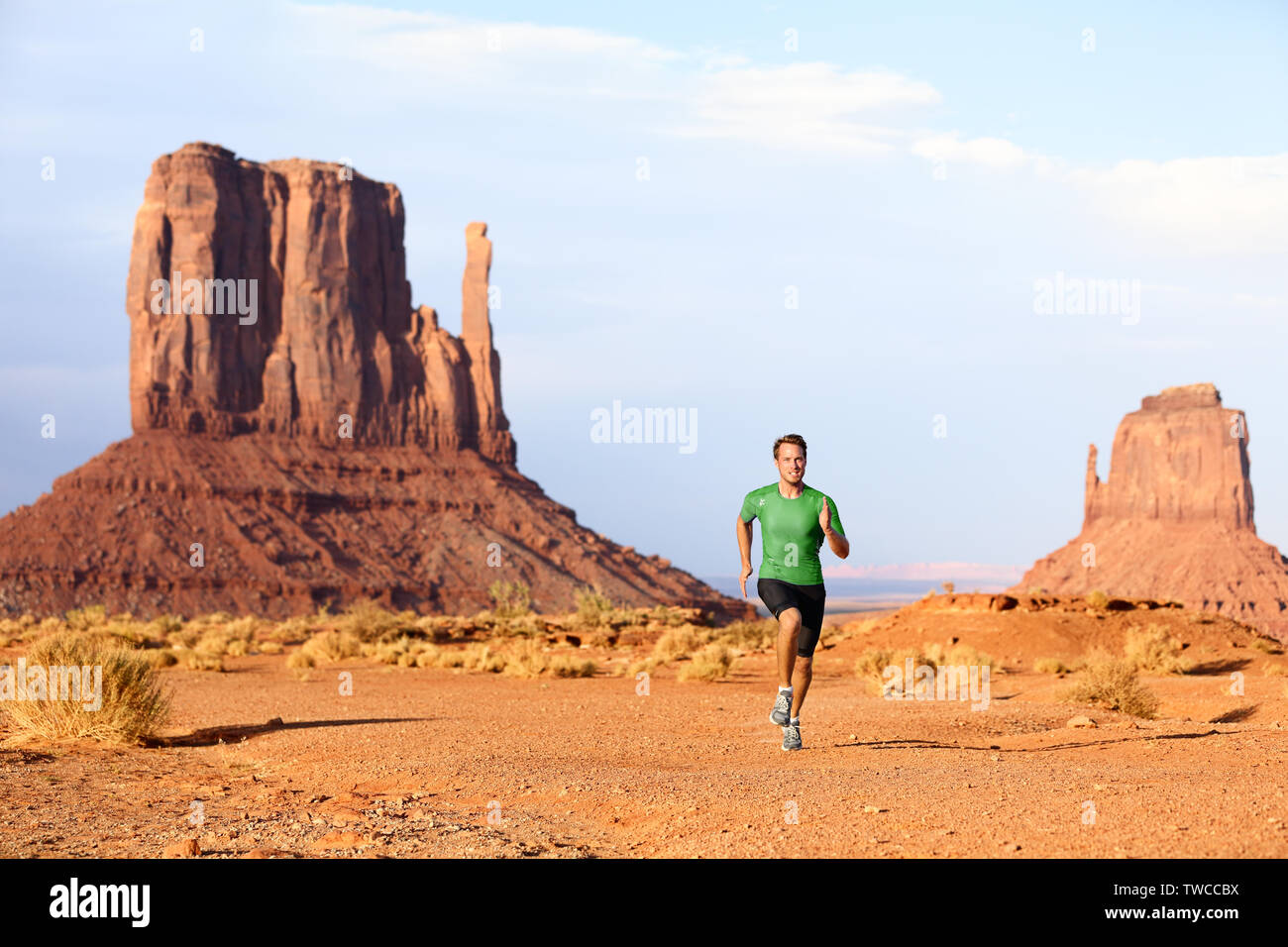 Runner. Running man sprinting in Monument Valley. Athlete runner cross ...