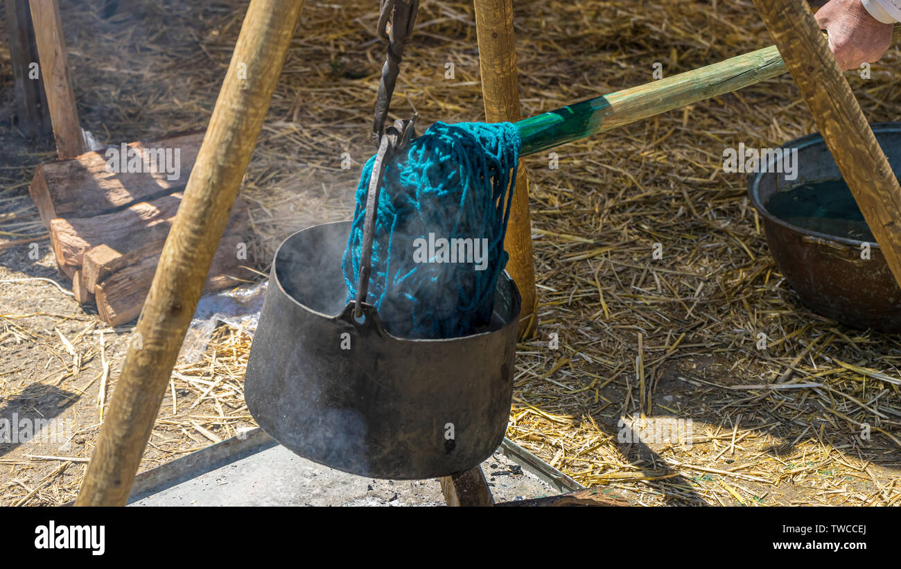 Tradition handmade dyeing of fabrics and wool in a cauldron with ...