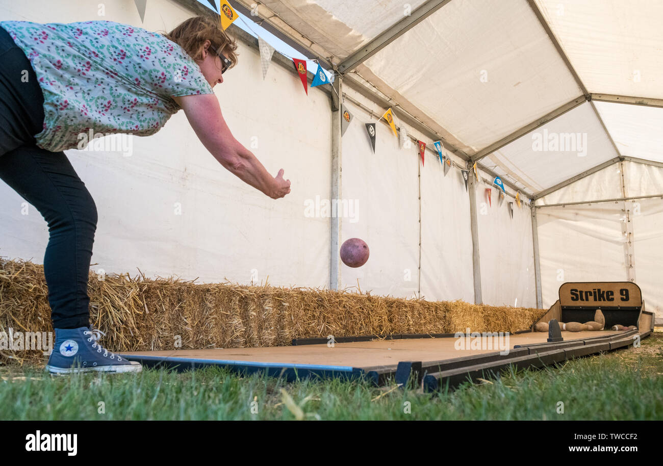 Female playing 9 pin bowling inside a long canvas tent Stock Photo - Alamy