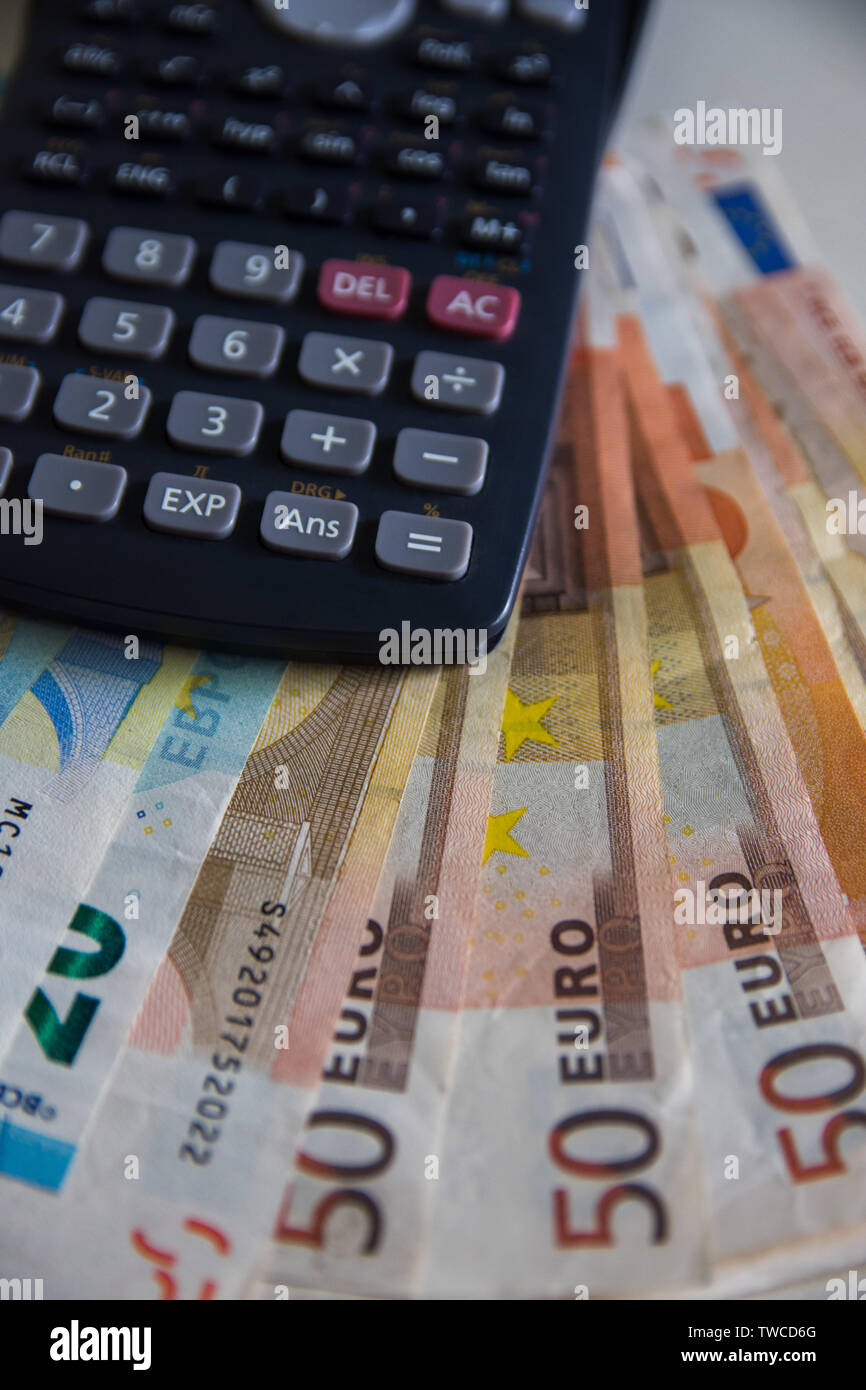 A black calculator with euro money Stock Photo - Alamy