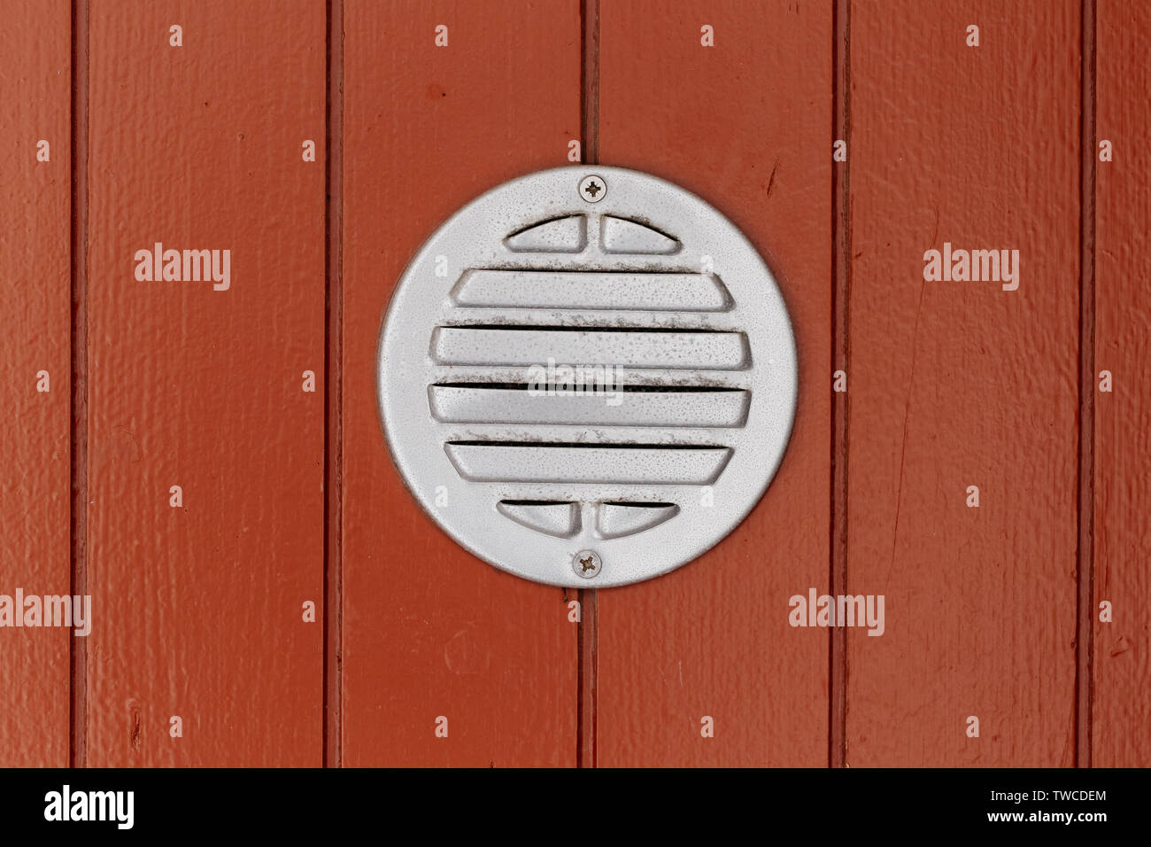 round ventilation grille on a wooden background Stock Photo - Alamy