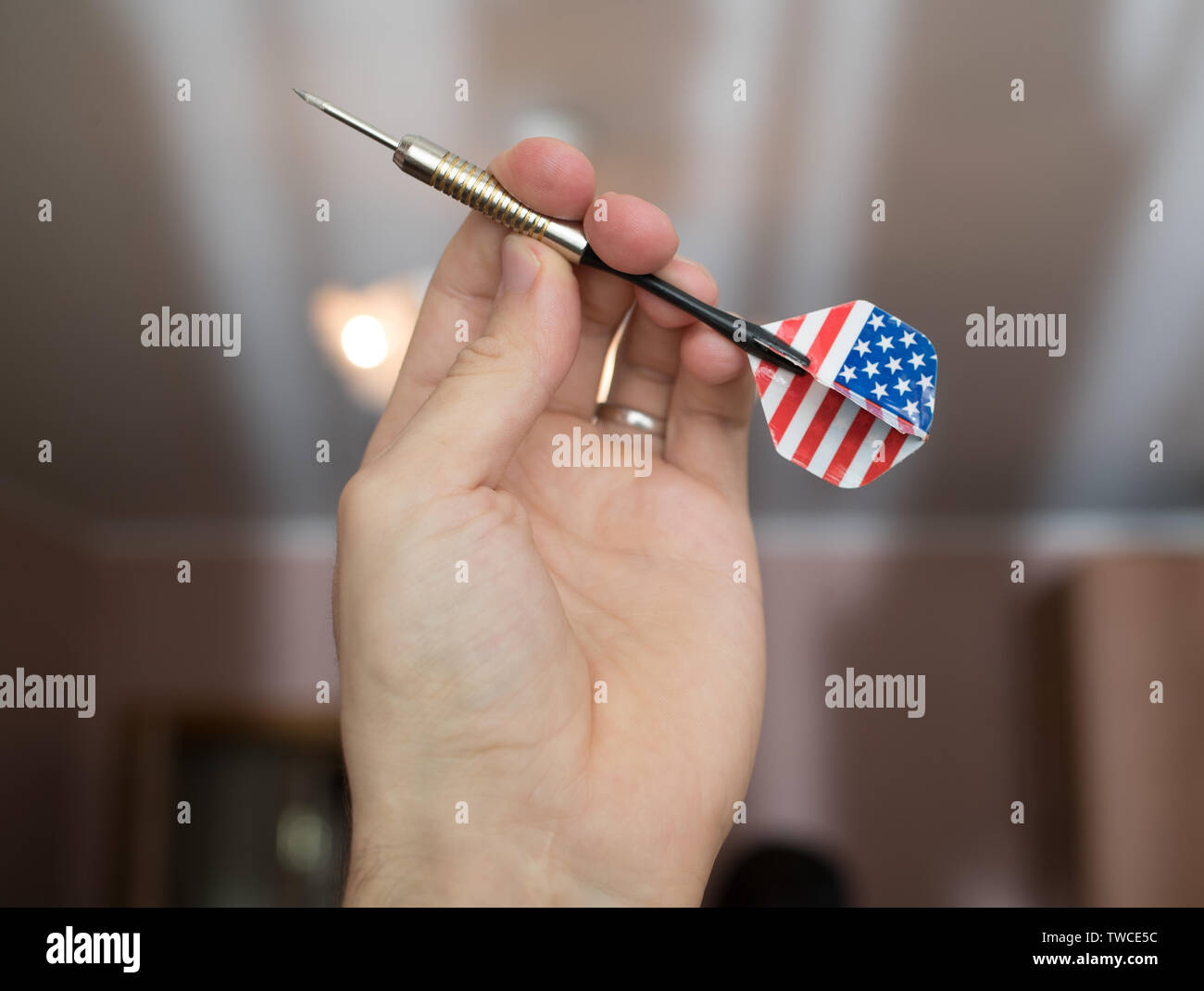 dart in hand closeup Stock Photo - Alamy