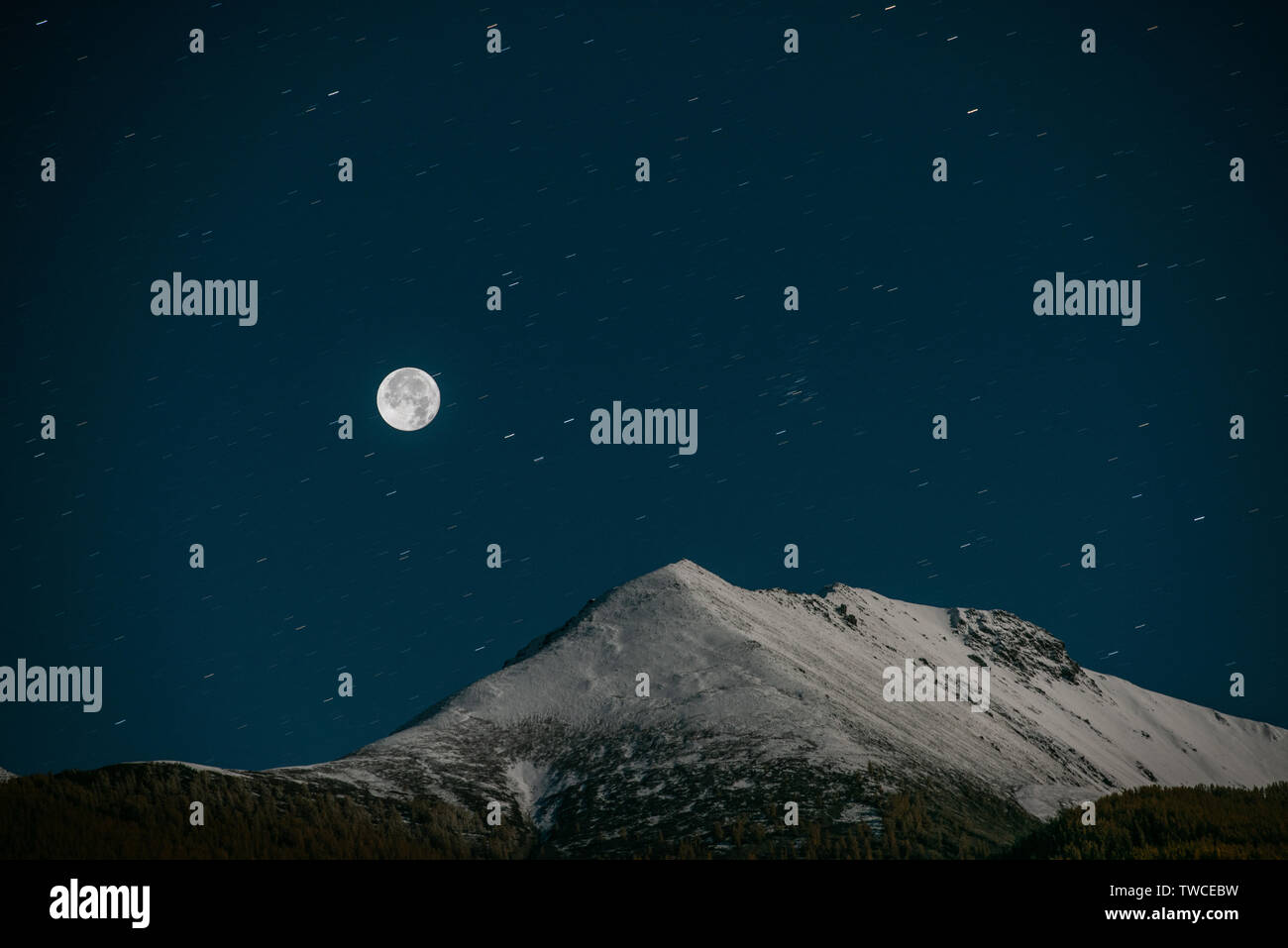 The moon on the top of the mountain Stock Photo - Alamy