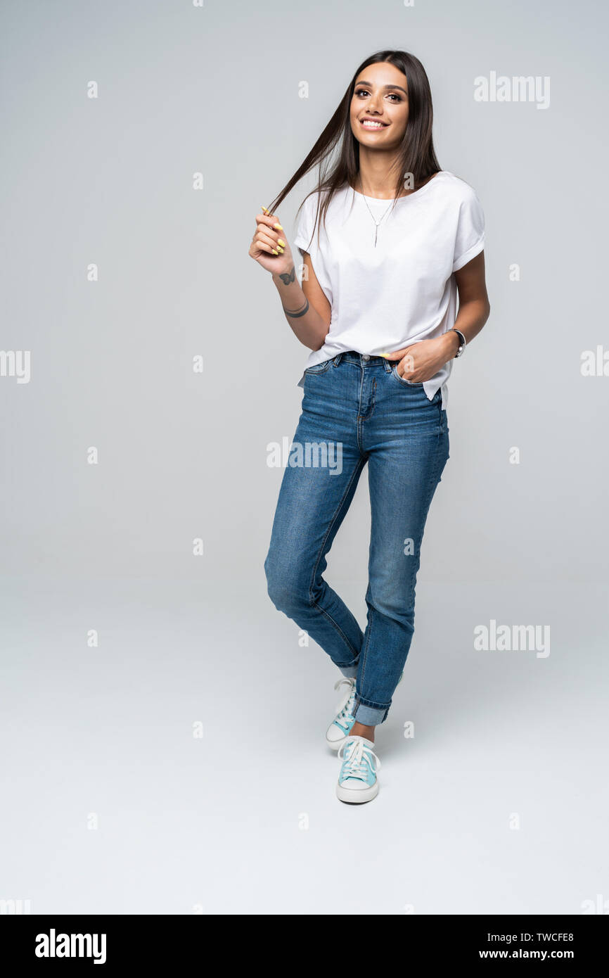 Full length portrait of a smiling pretty woman isolated over white ...