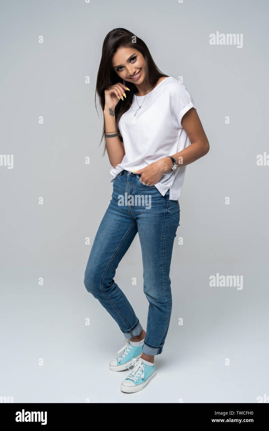 Full length portrait of a smiling pretty woman isolated over white ...