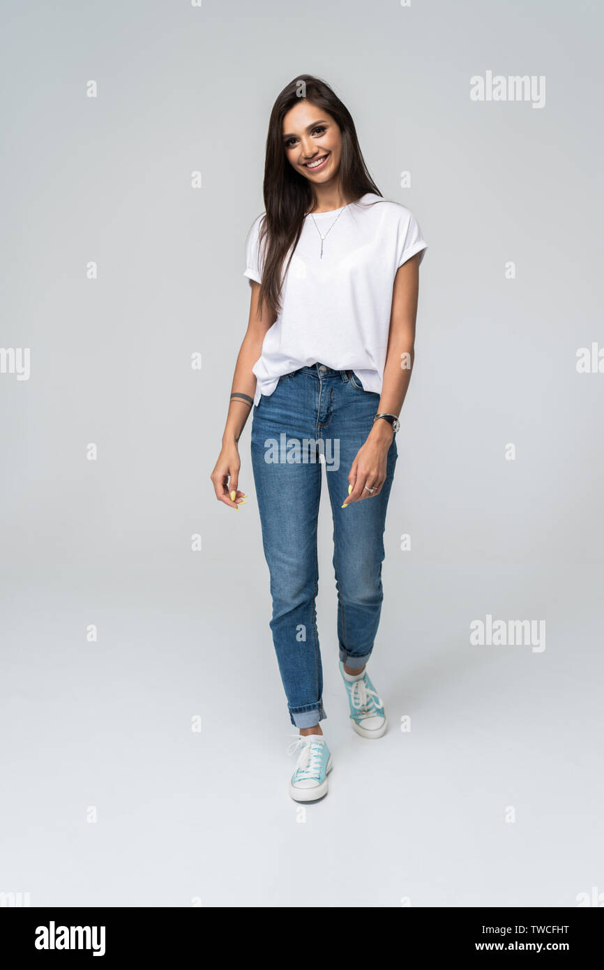 Full length portrait of a smiling pretty woman isolated over white ...