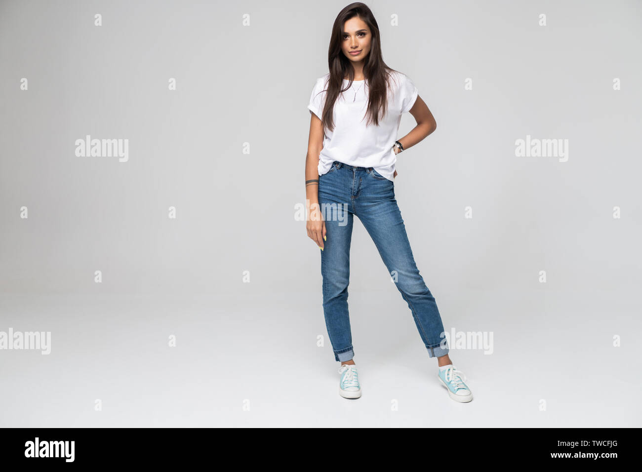 Full length portrait of a smiling pretty woman isolated over white ...