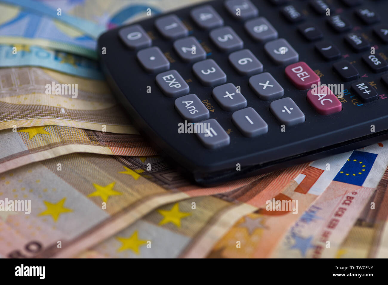 A black calculator with euro money Stock Photo - Alamy