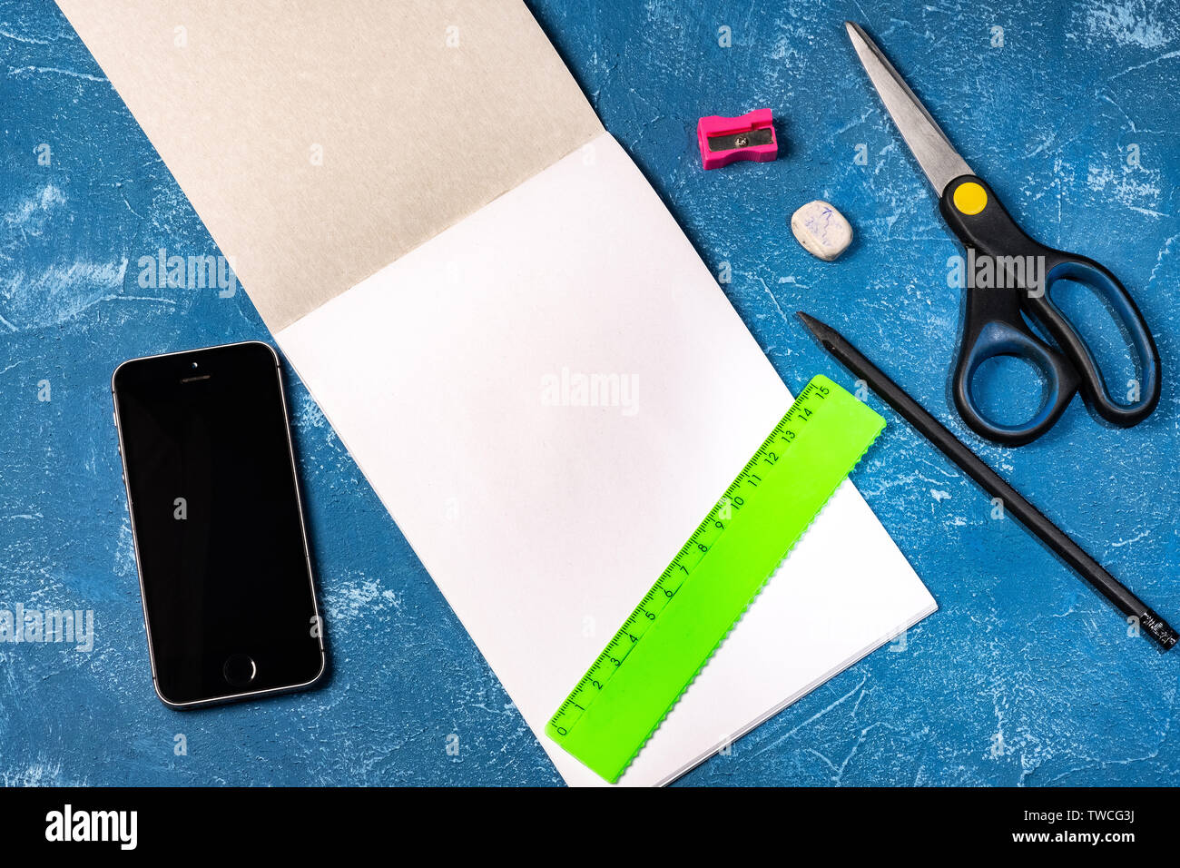 drawing pad and colored pencils on blue background Stock Photo - Alamy