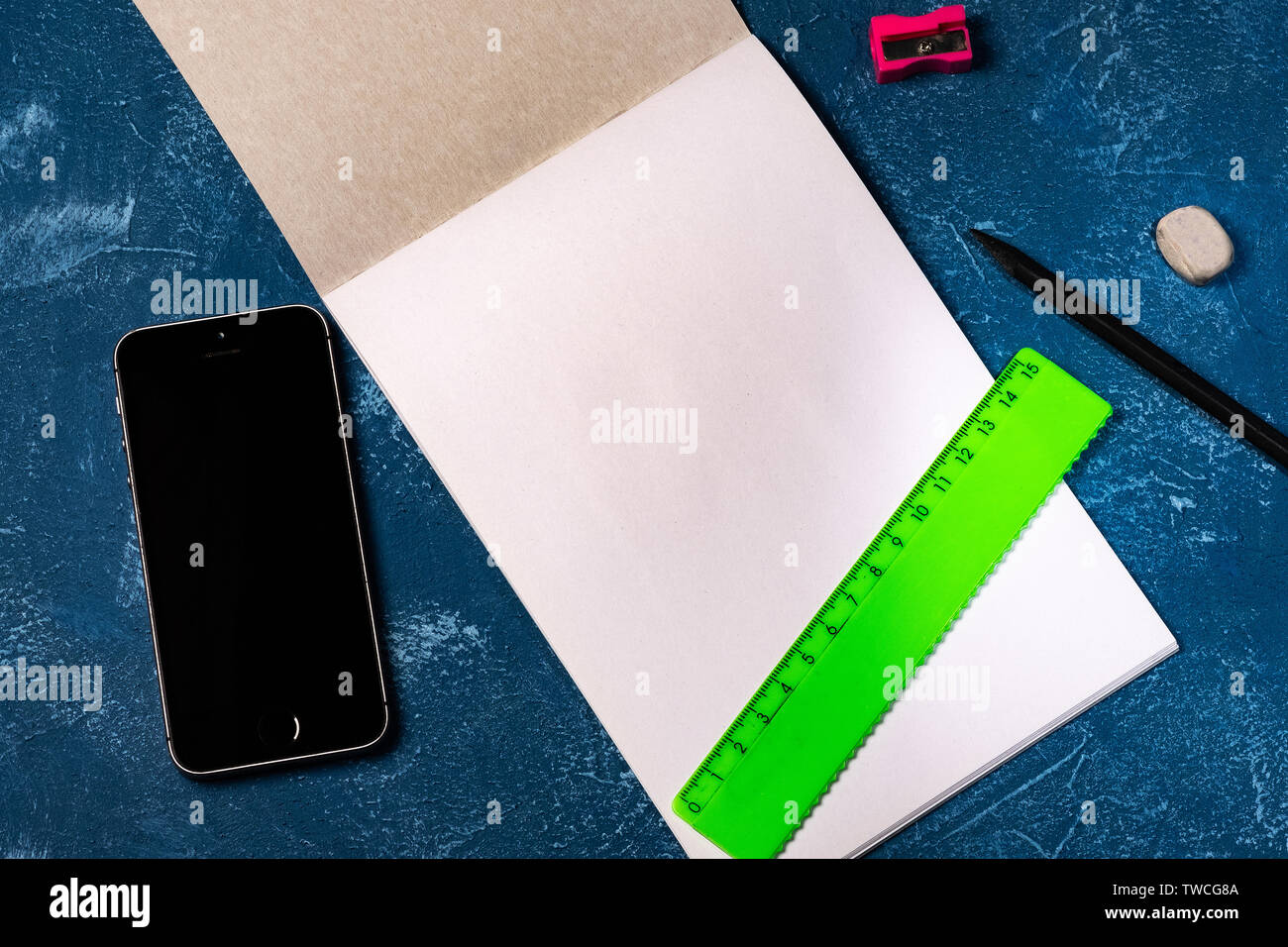 drawing pad and colored pencils on blue background Stock Photo - Alamy