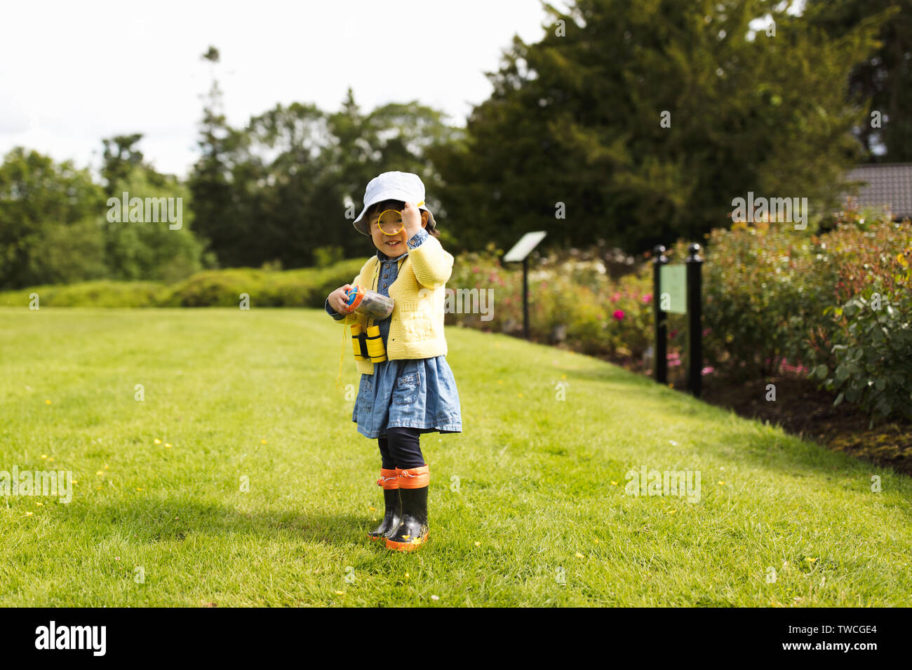 toddler girl playing exploration in spring park Stock Photo - Alamy