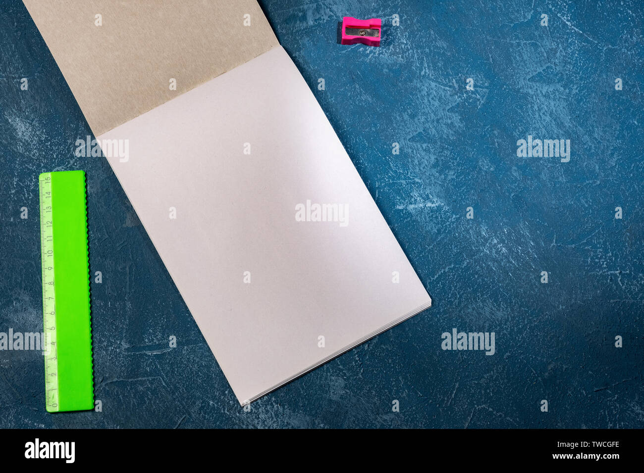 drawing pad and colored pencils on blue background Stock Photo - Alamy