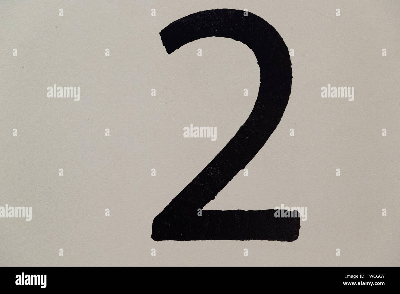 black number 2 on a light wall Stock Photo - Alamy