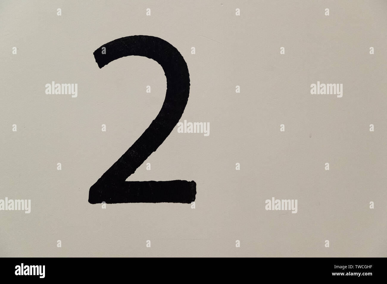 black number 2 on a light wall Stock Photo - Alamy