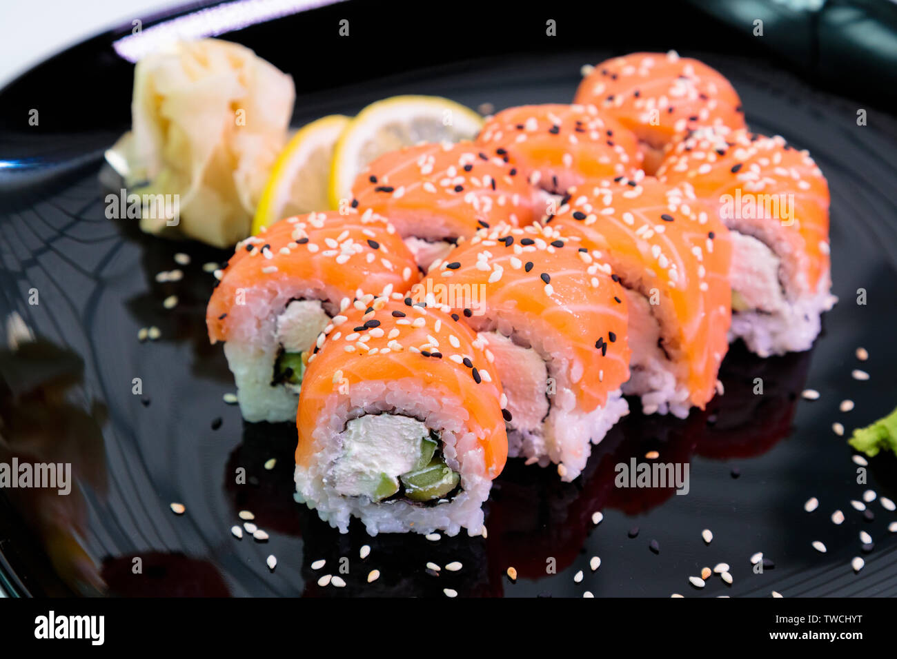 photo of Japanese rolls in a black plate Stock Photo - Alamy