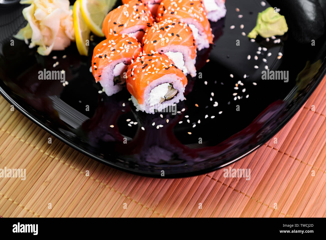 photo of Japanese rolls in a black plate Stock Photo - Alamy