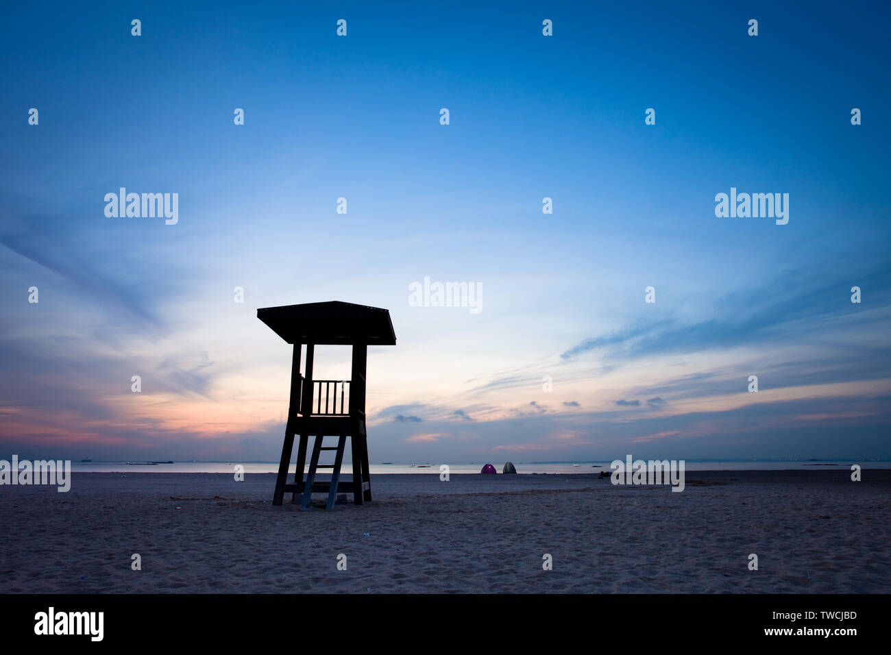 Observation tower on the beach with sunrise Stock Photo - Alamy