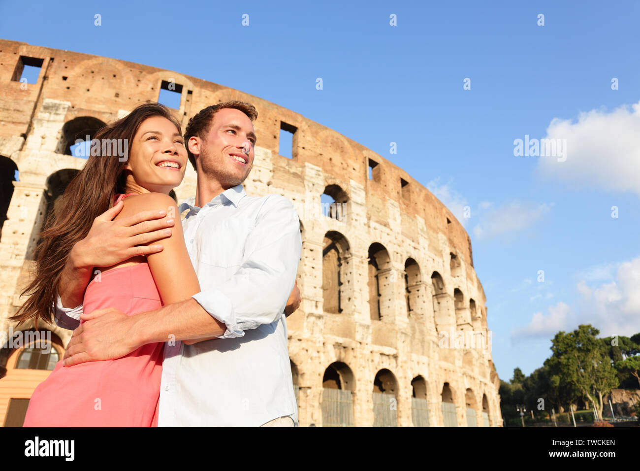 Romantic travel couple in Rome by Coliseum embracing in Italy. Happy ...