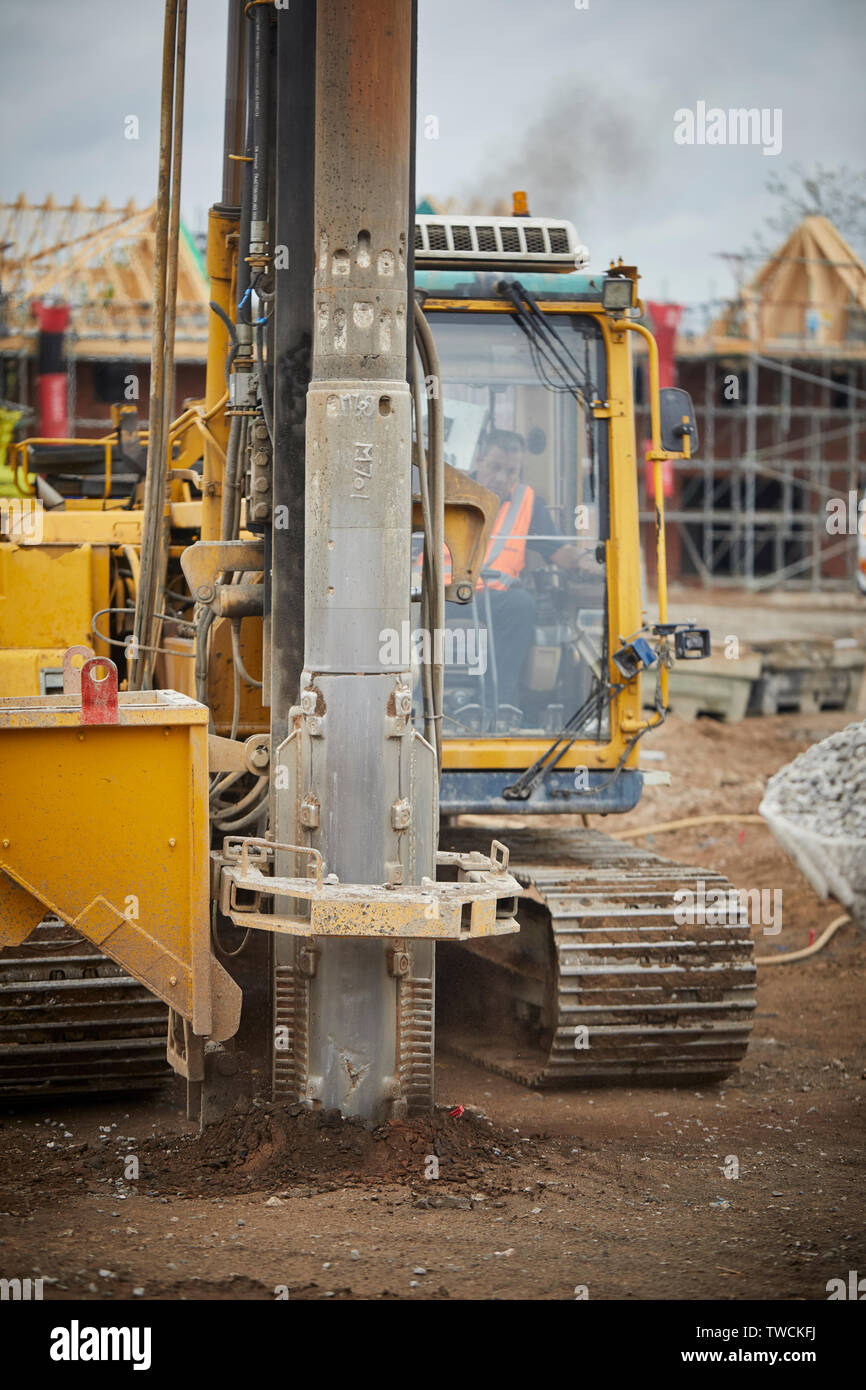 Pile driver rig at work on a building site for new homes in Cheshire ...