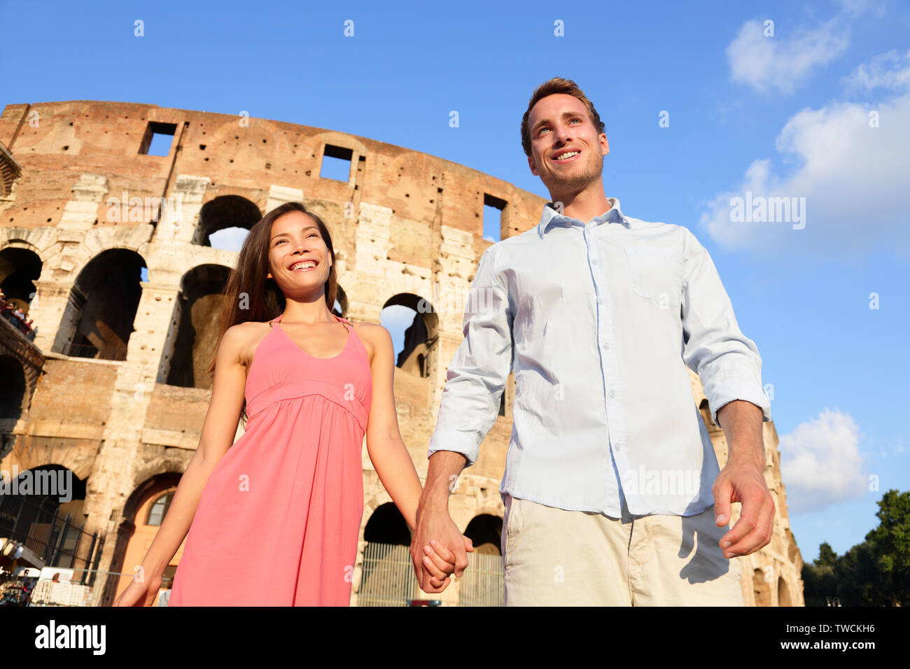 Couple in Rome by Colosseum walking holding hands in Italy. Happy ...