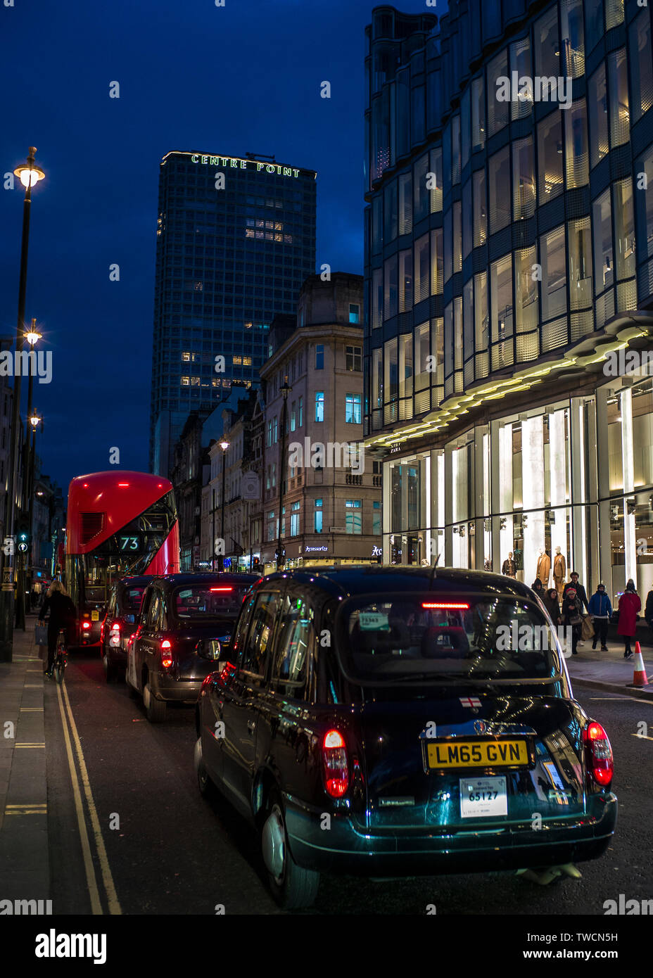 Black cabs and London double decker bus Oxford street at night with ...