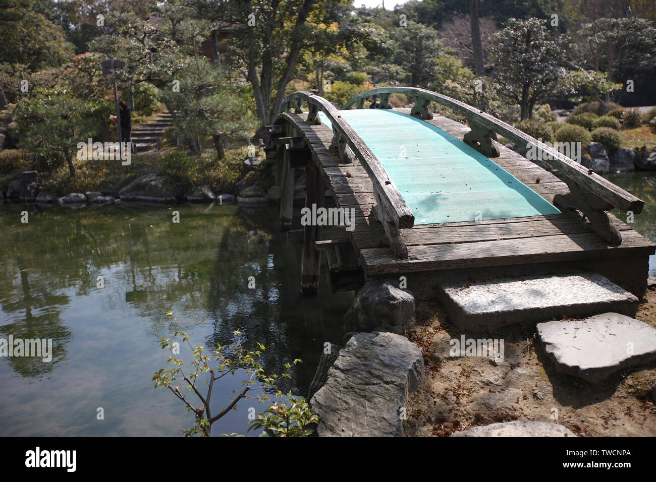 The old wooden bridge over a pond in a beautiful park. Tokyo, Japan ...