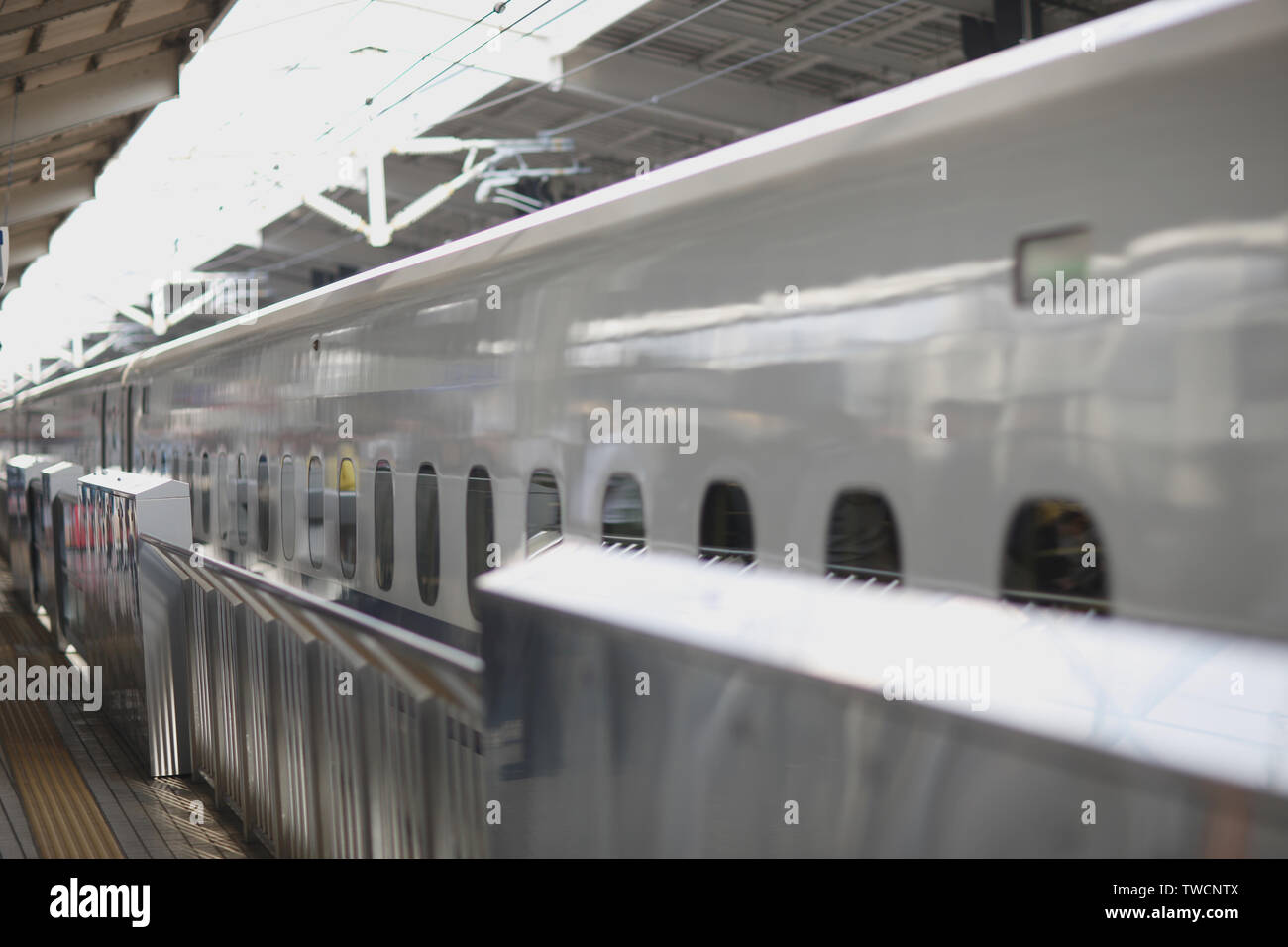 Modern train at the platform at the train station. Japan Stock Photo ...