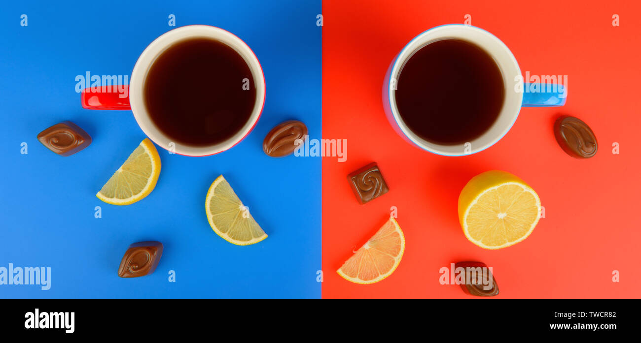 Red and blue cups with tea , lemon slices and chocolate candies on a ...