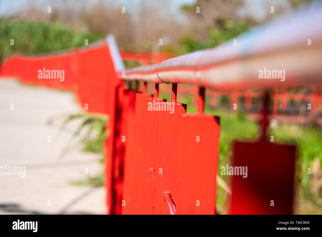 Iron railing painted orange in escape in a public park Stock Photo - Alamy