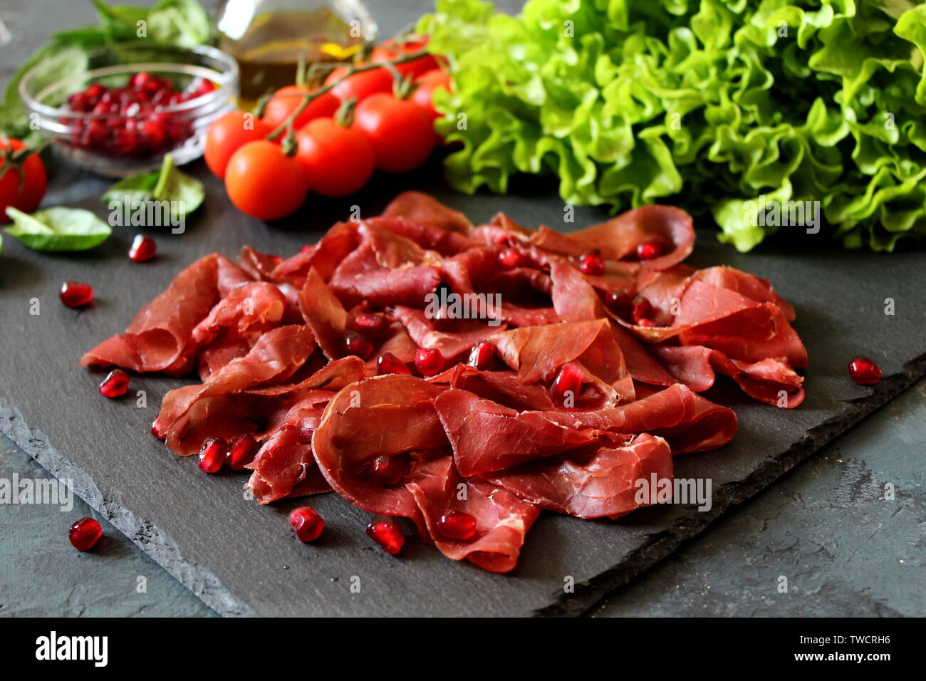 Italian air-dried salted bresaola beef thinly sliced and stone ...