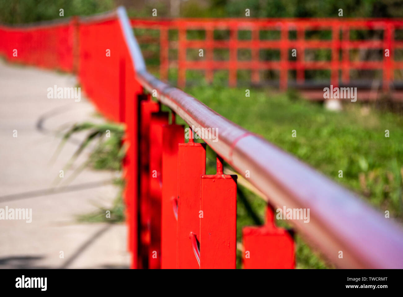 Iron railing painted orange in escape in a public park Stock Photo - Alamy