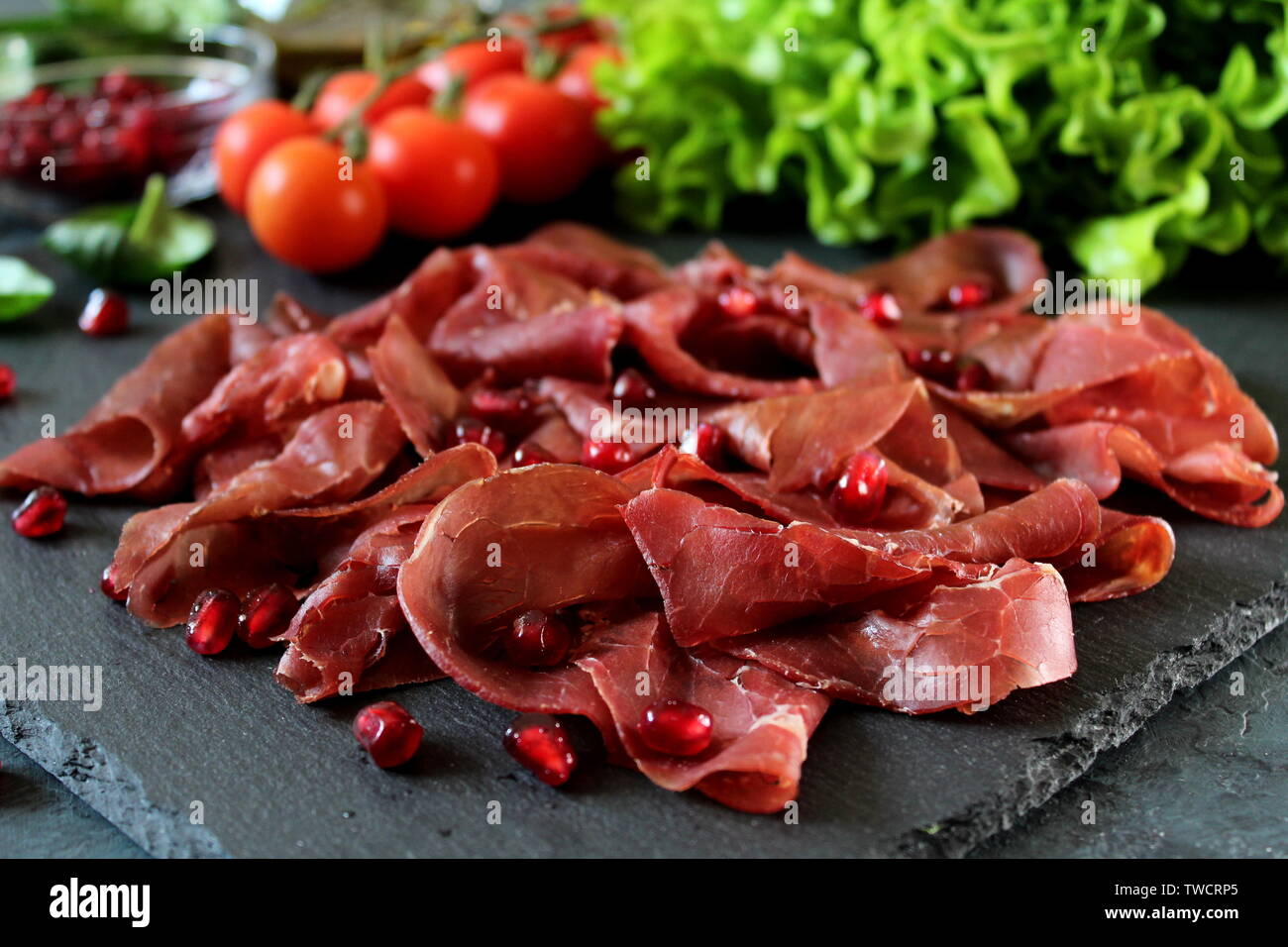 Italian air-dried salted bresaola beef thinly sliced and stone ...