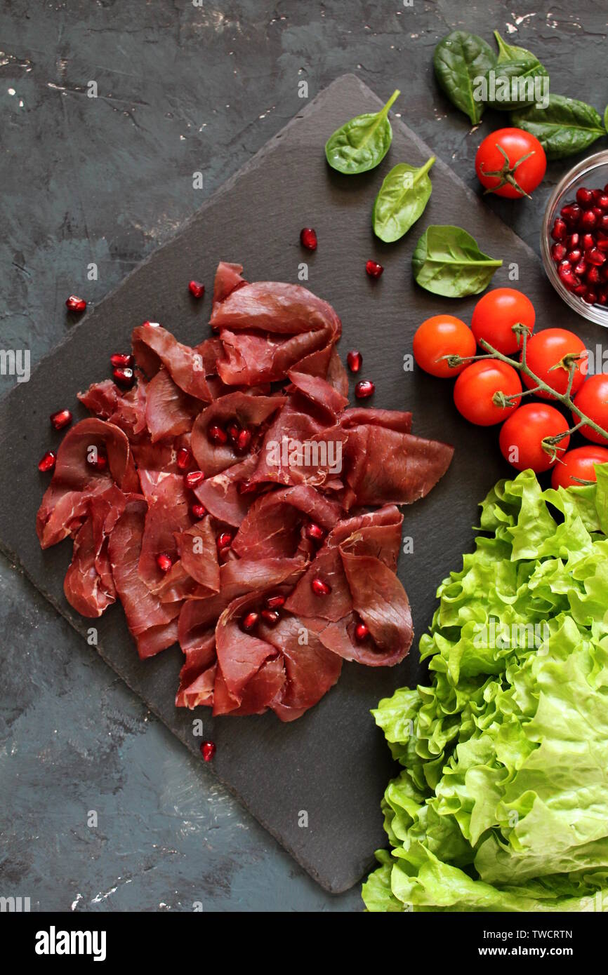 Italian air-dried salted bresaola beef thinly sliced and stone ...