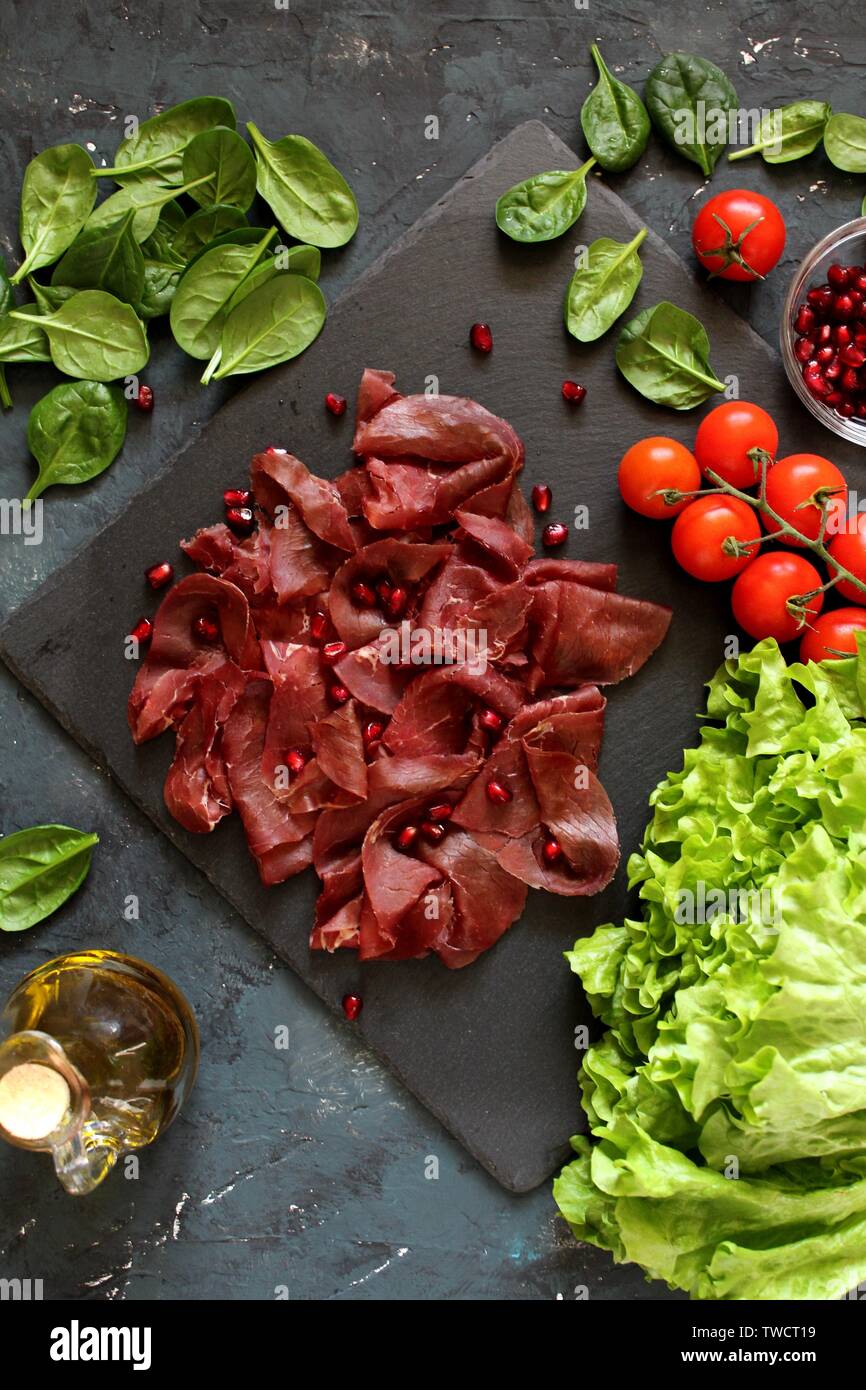 Italian air-dried salted bresaola beef thinly sliced and stone ...