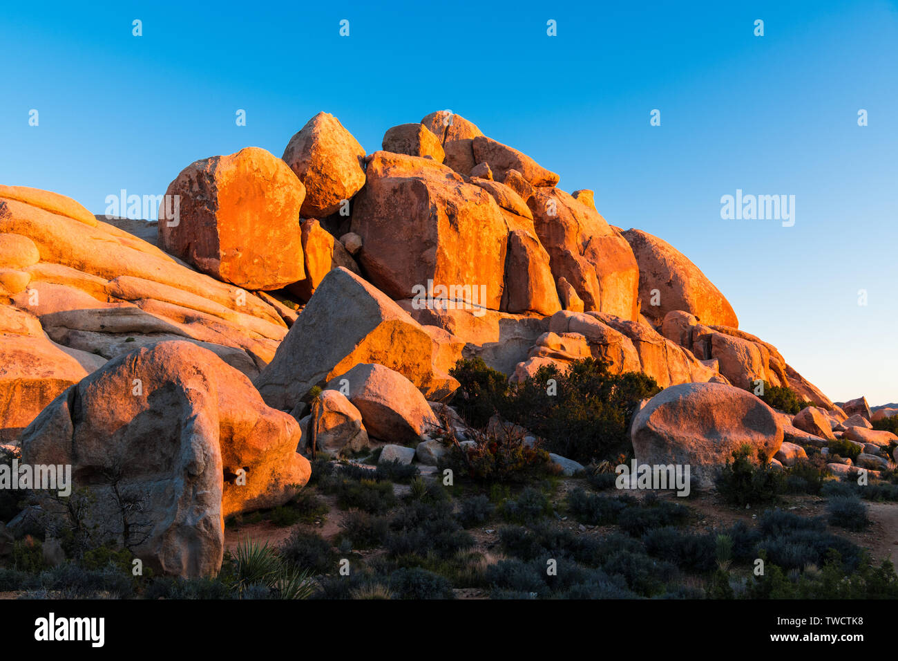 Rock formation of huge sandstone boulders glowing in the golden light ...