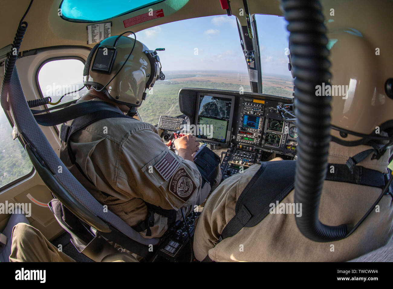 U.S. Border Patrol agents use a helicopter to search for Central ...