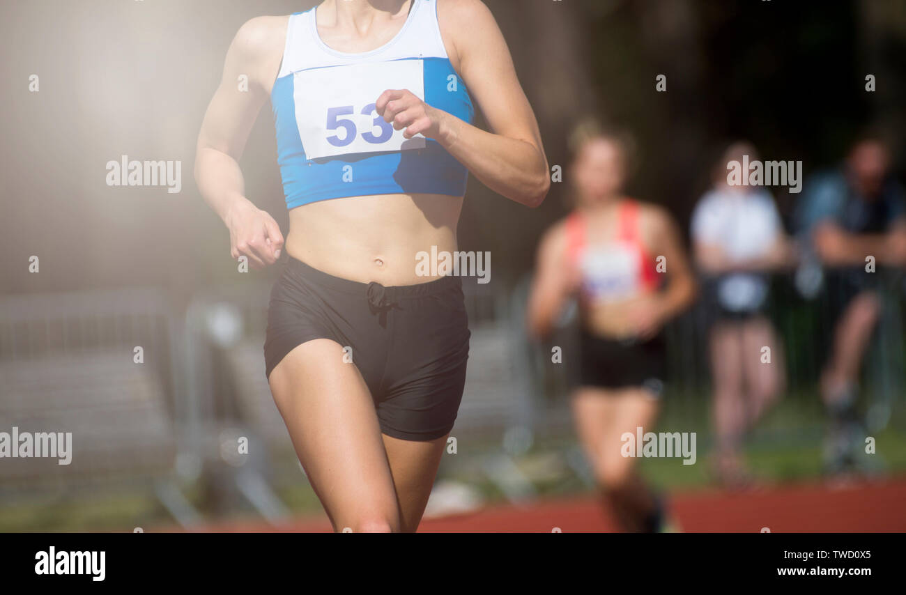 Athletics people running on the track field. Sunny day Stock Photo - Alamy