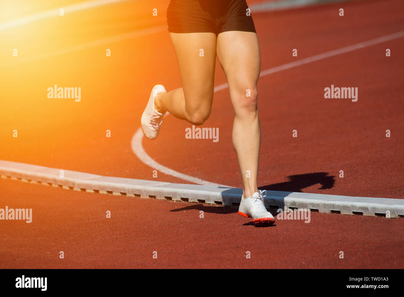 Athletics woman running on the track field Stock Photo - Alamy
