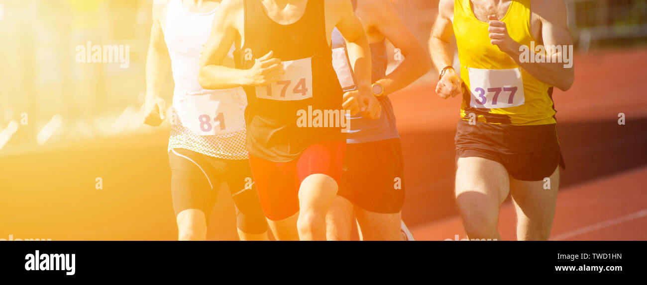 Athletics people running on the track field. Sunny day Stock Photo - Alamy