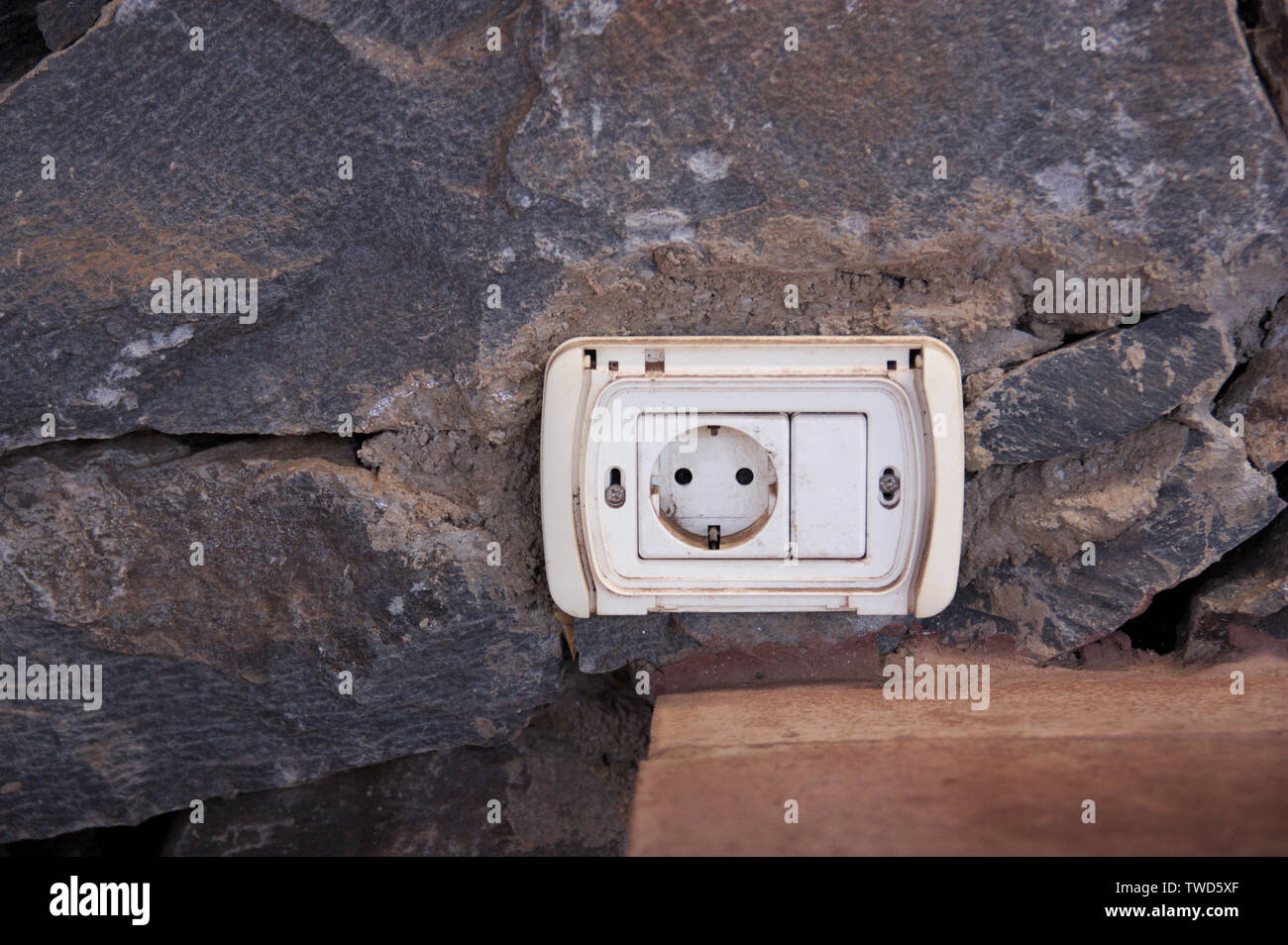 Image of an aged plug placed in a rustic stone wall with space to the ...