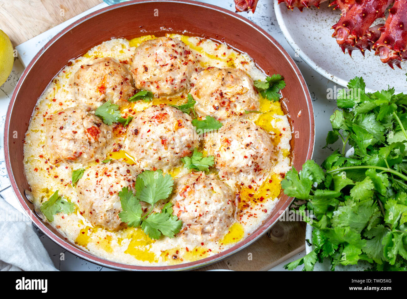 CRABMEATBALLS crab meatballs in white creamy sauce in red pan, whole ...
