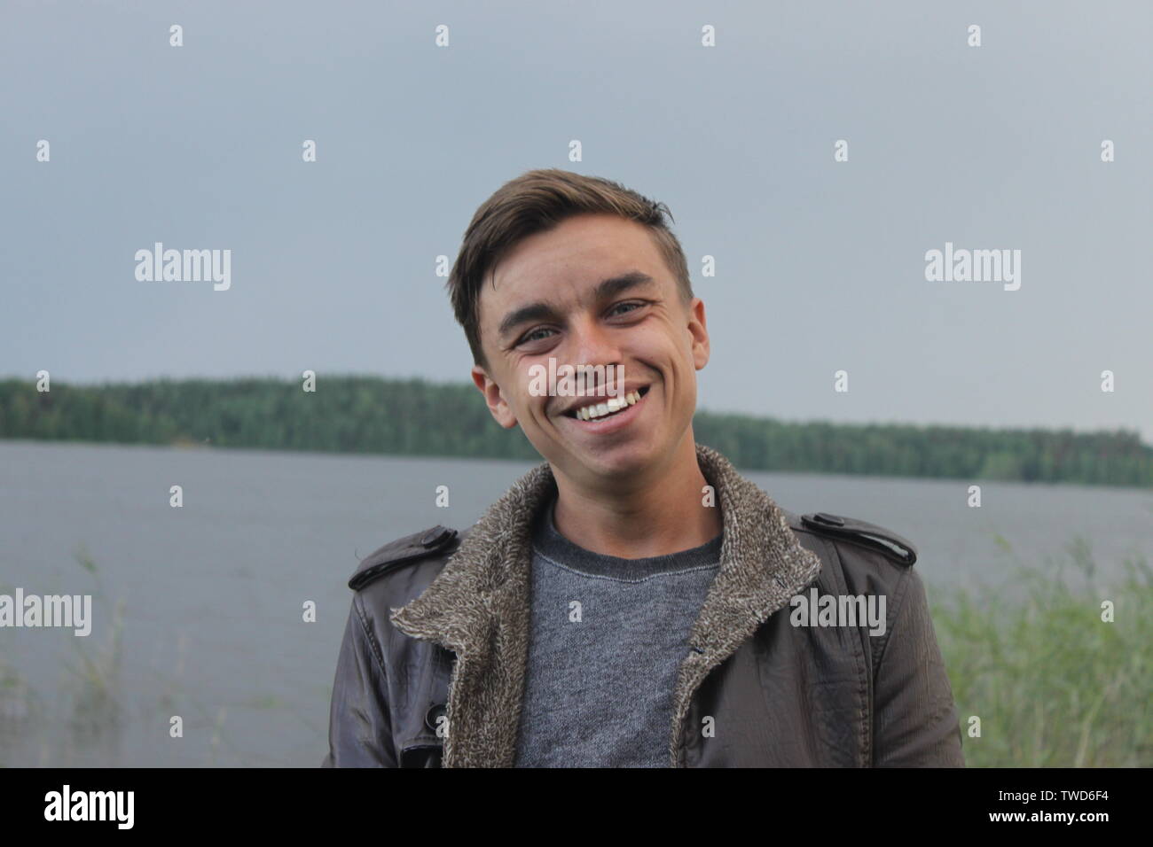 Handsome young man in jacket in Finland Stock Photo - Alamy