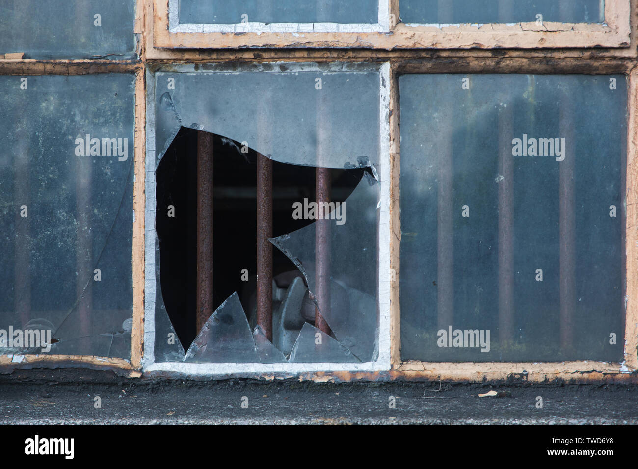 Close-up of smashed and broken rectangular glass window pane set in ...