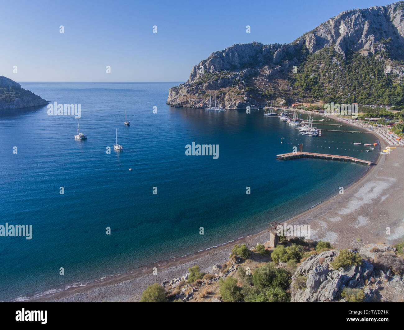 Bending a pebble beach. Resort area in the Bay on the Mediterranean ...