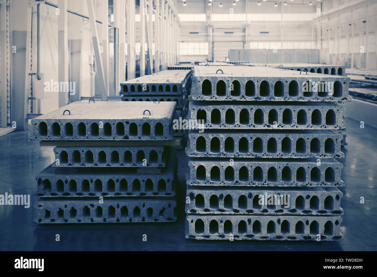 Stack of precast reinforced concrete slabs in a house-building factory ...
