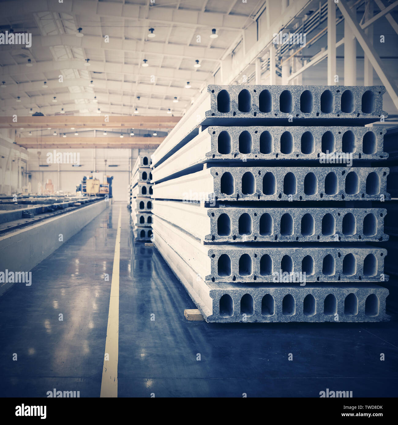 Stack of precast reinforced concrete slabs in a house-building factory ...