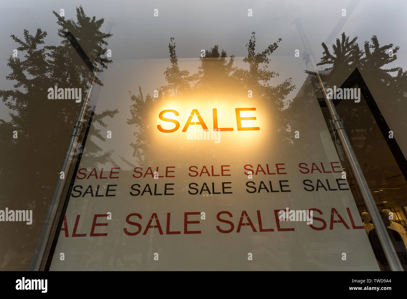 sale poster in the displaywindow of shop Stock Photo - Alamy