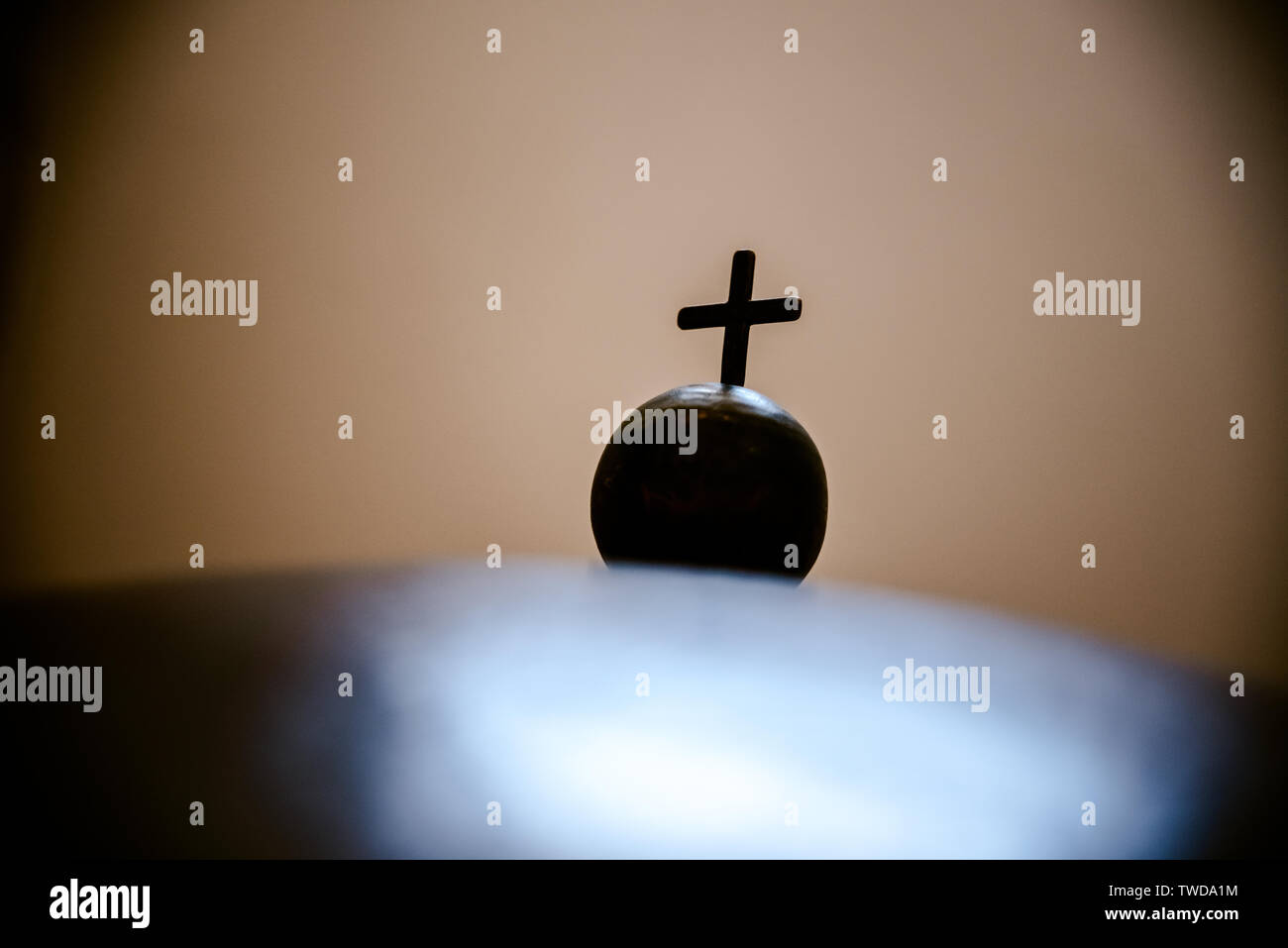 Christian cross on a small metal ball, negative space Stock Photo - Alamy