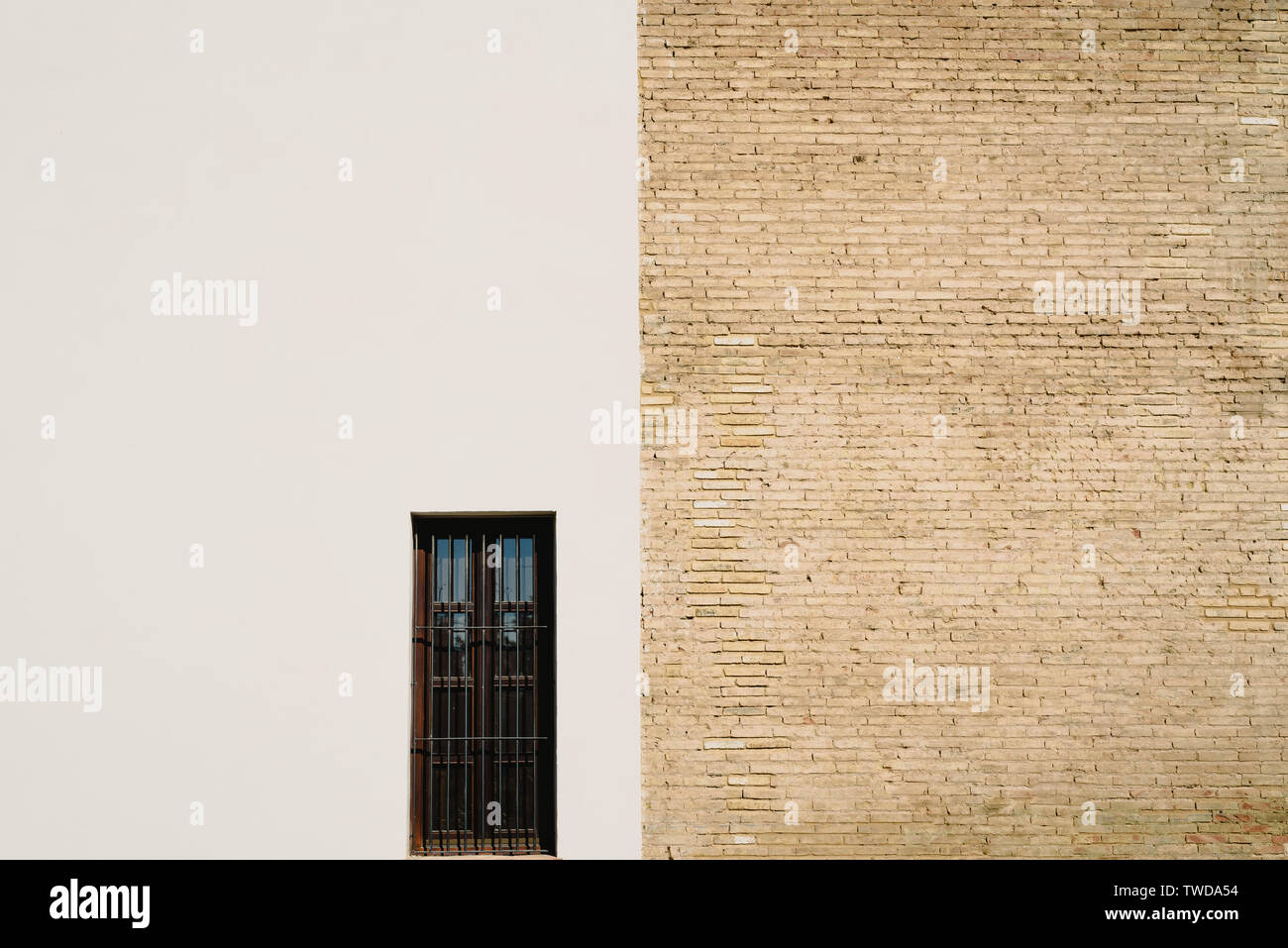 Background of a wall half white and half with bricks, divided into two ...